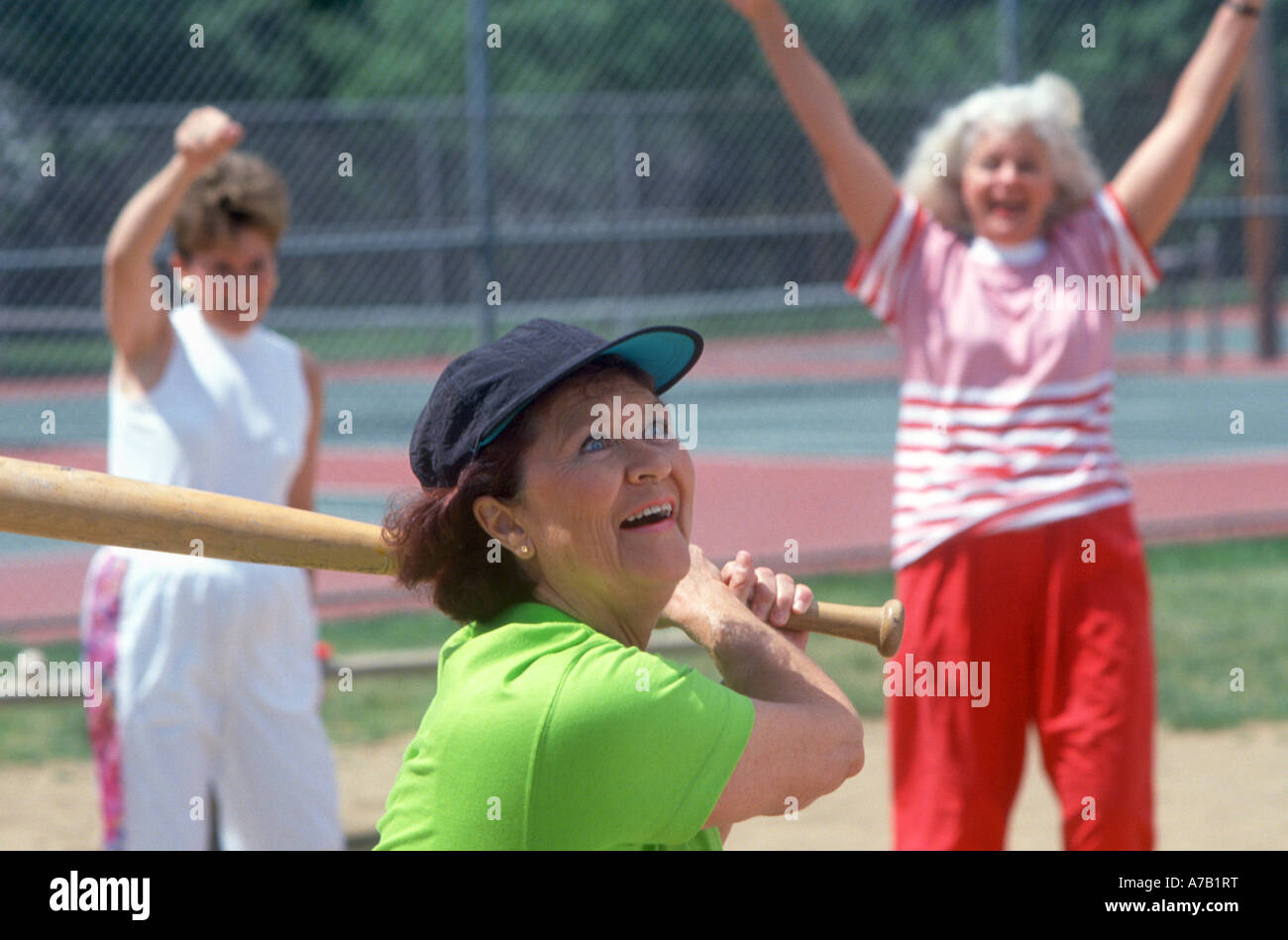 Mature softball player connects with the ball Stock Photo - Alamy