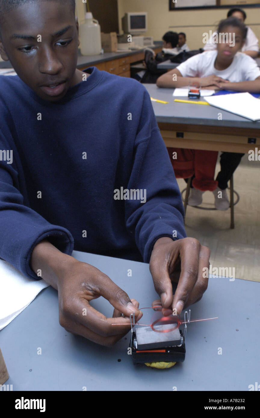 African American student building an electric motor in a science class ...