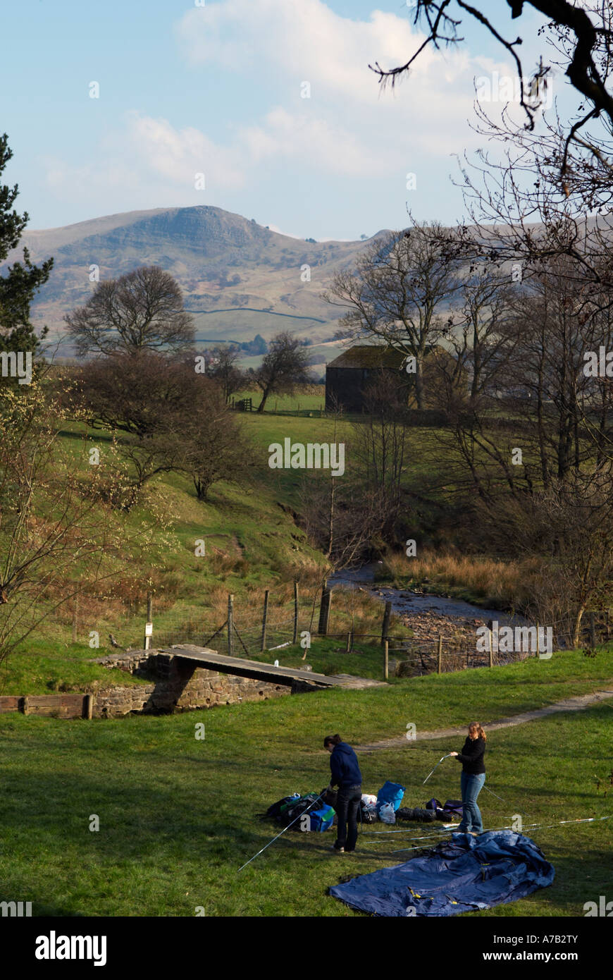 Two female campers setting up a tent at Fieldhead Campsite in Edale in ...