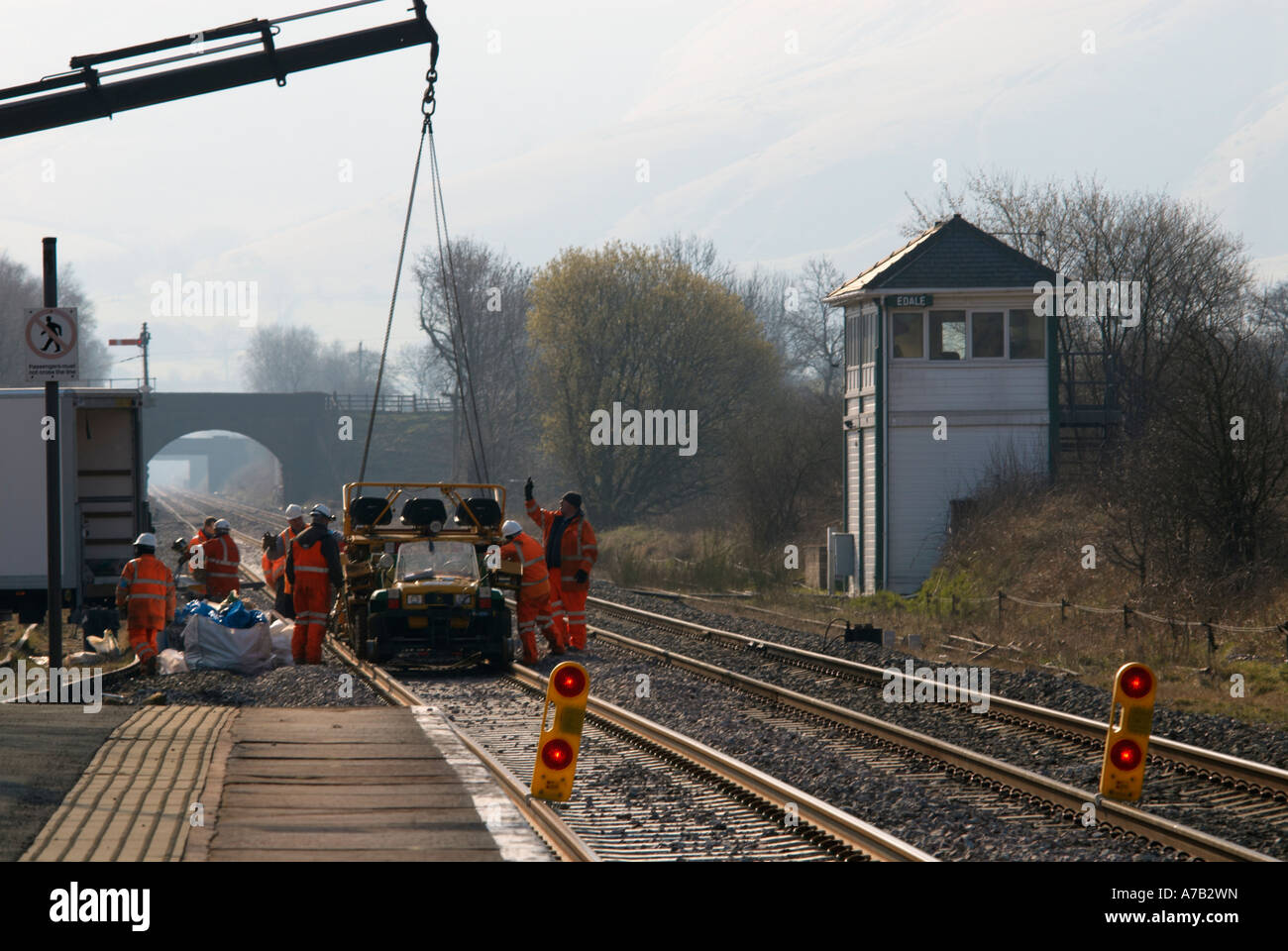 Railway workers using a rail side crane at Edale Station in Derbyshire ...