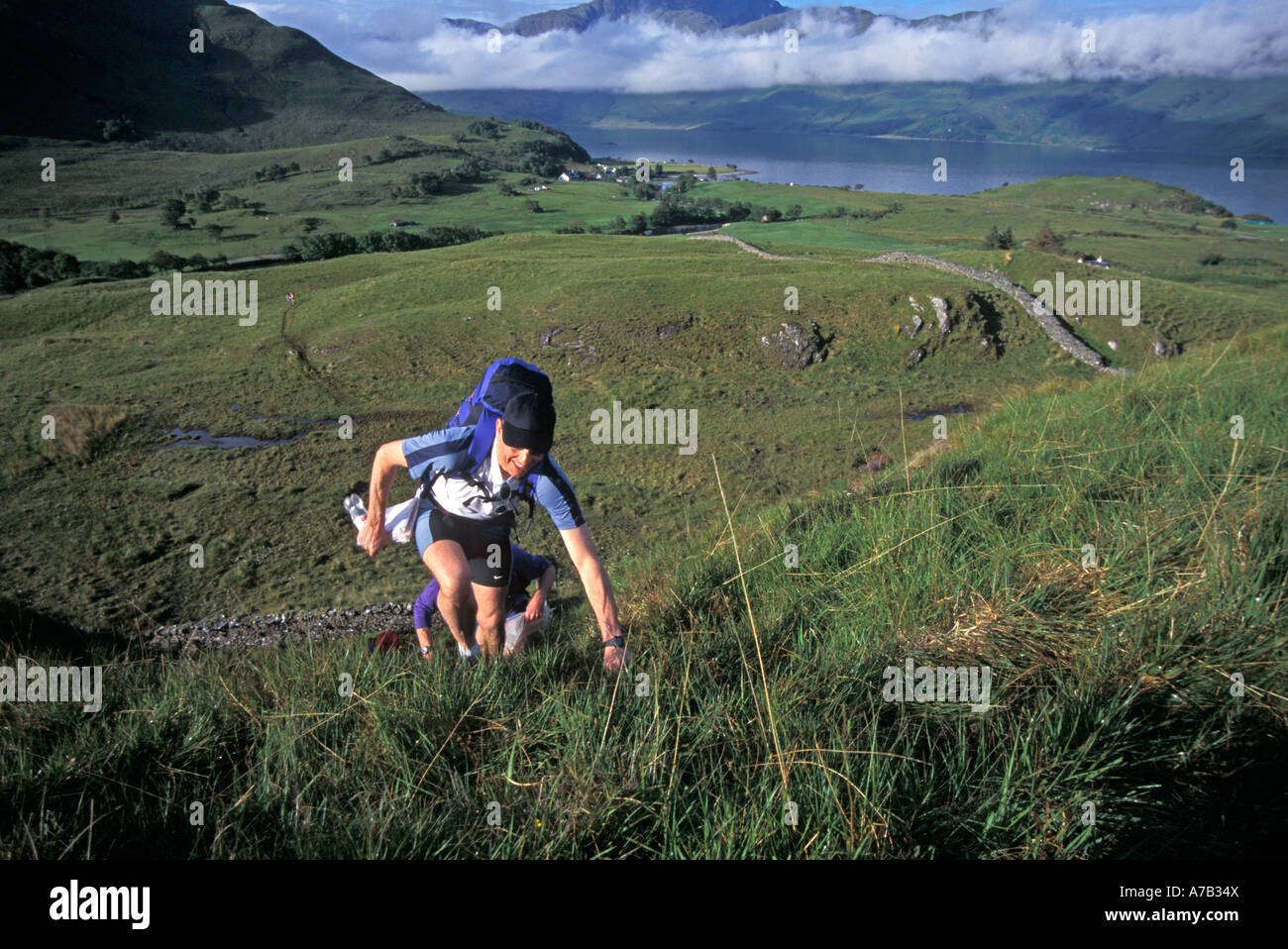Two men adventure racing in Scotland Stock Photo - Alamy