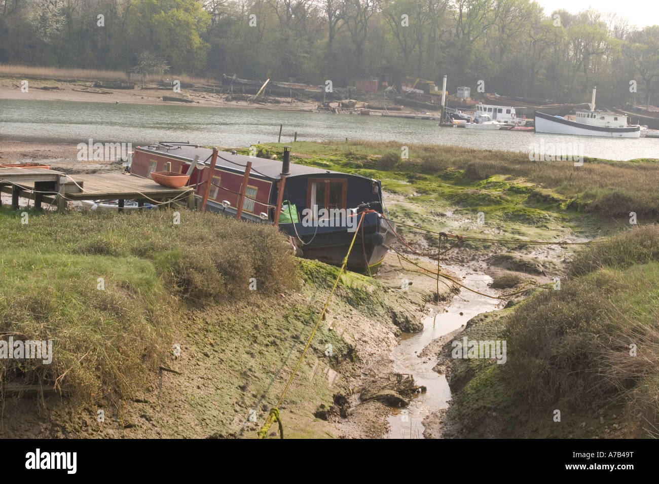 Moored houseboat at low tide on the River Hamble, Hamble, Hampshire ...