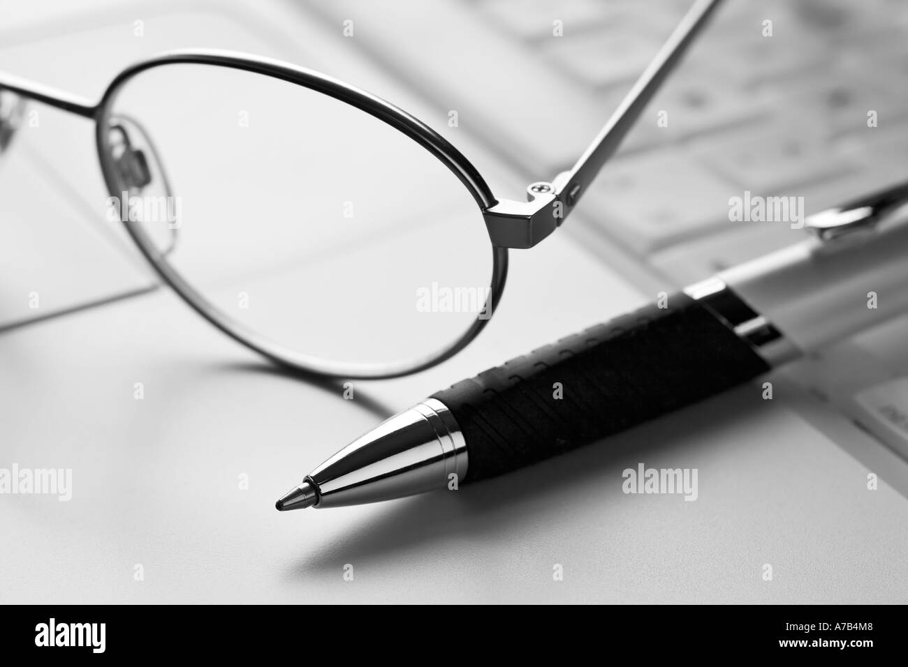 Reading glasses, pen and laptop Stock Photo - Alamy