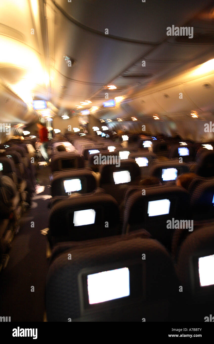 interior of airplane with seat back television screens Stock Photo - Alamy