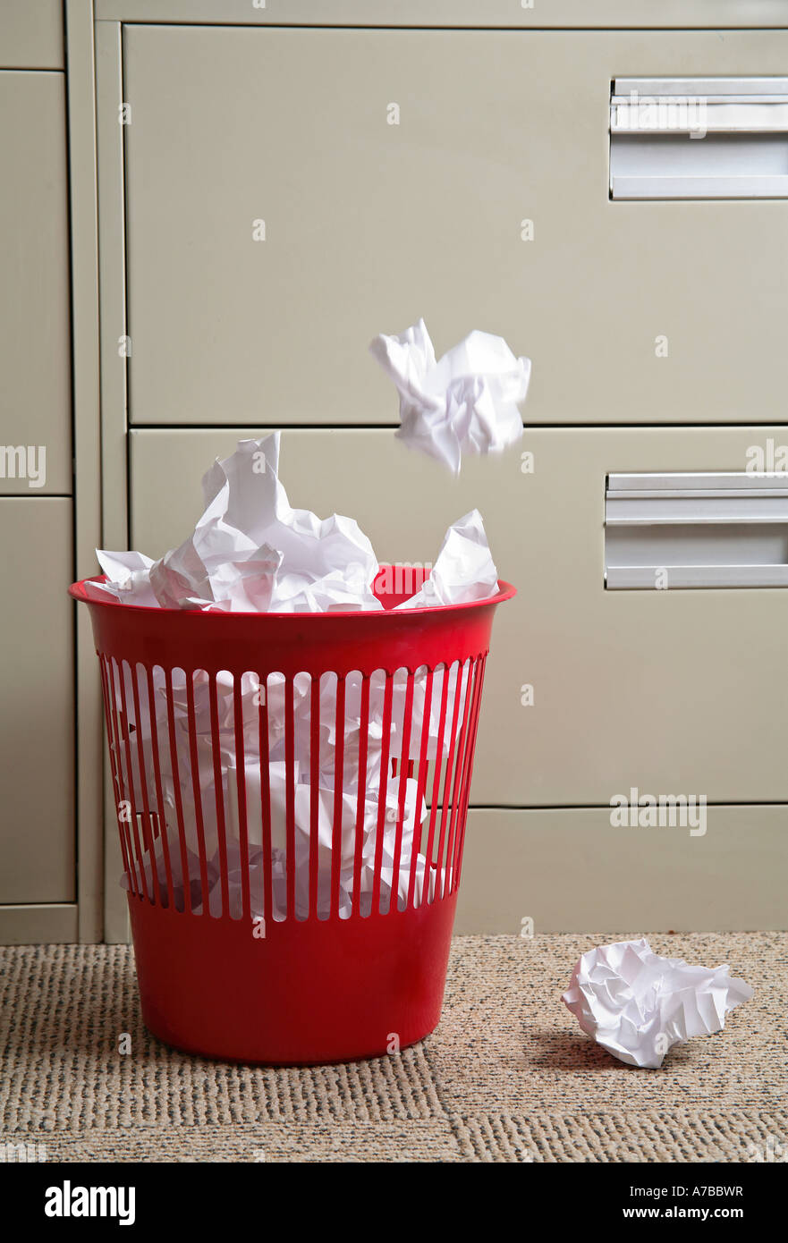 crumpled paper being tossed into waste basket Stock Photo - Alamy
