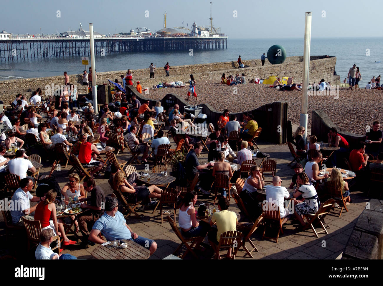Visitors enjoy food and drink at the OHSO bar on Brighton beach Stock ...