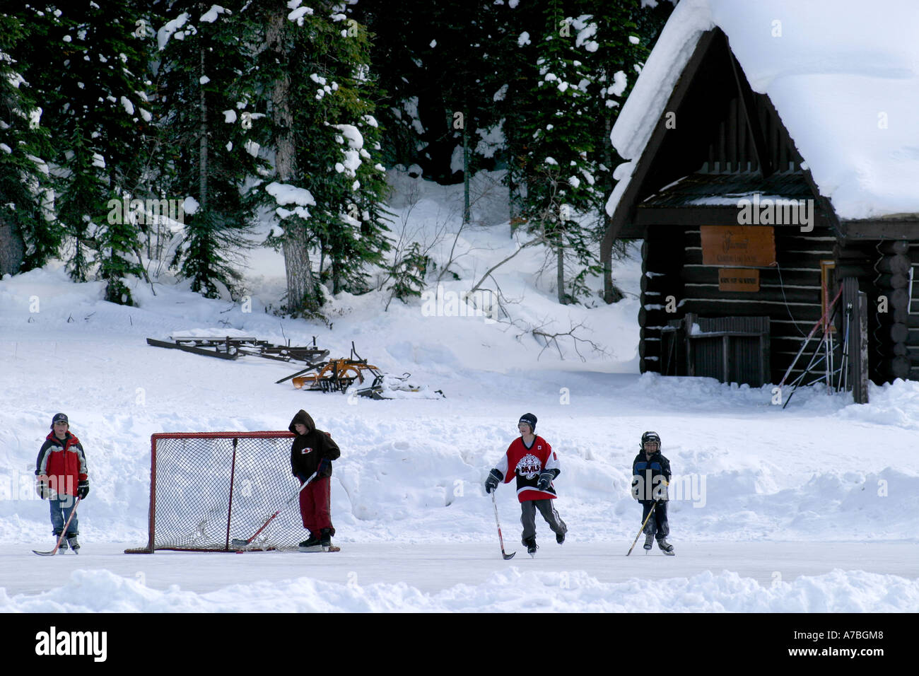 Children playing hockey on an outdoor ice rink Stock Photo - Alamy