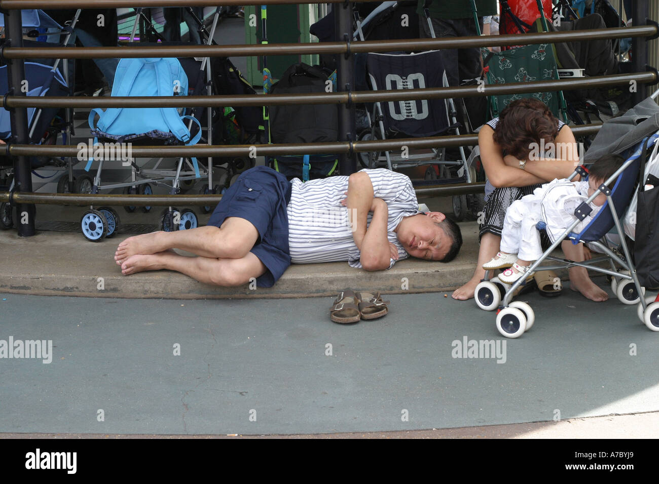 Tired family fallen asleep in a fun park Stock Photo - Alamy