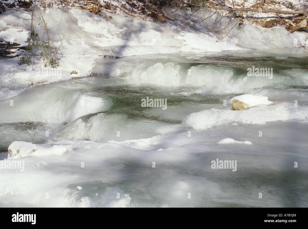 Stream flowing ice melting from the heat of the sun Montgomery VT USA ...