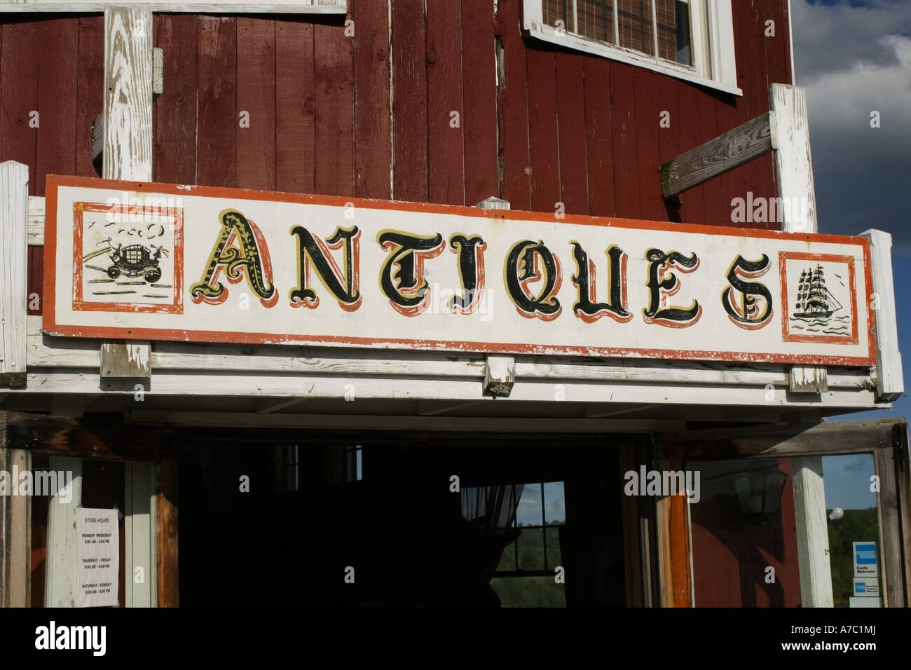 An antiques sign outside of an antigue shop Stock Photo - Alamy