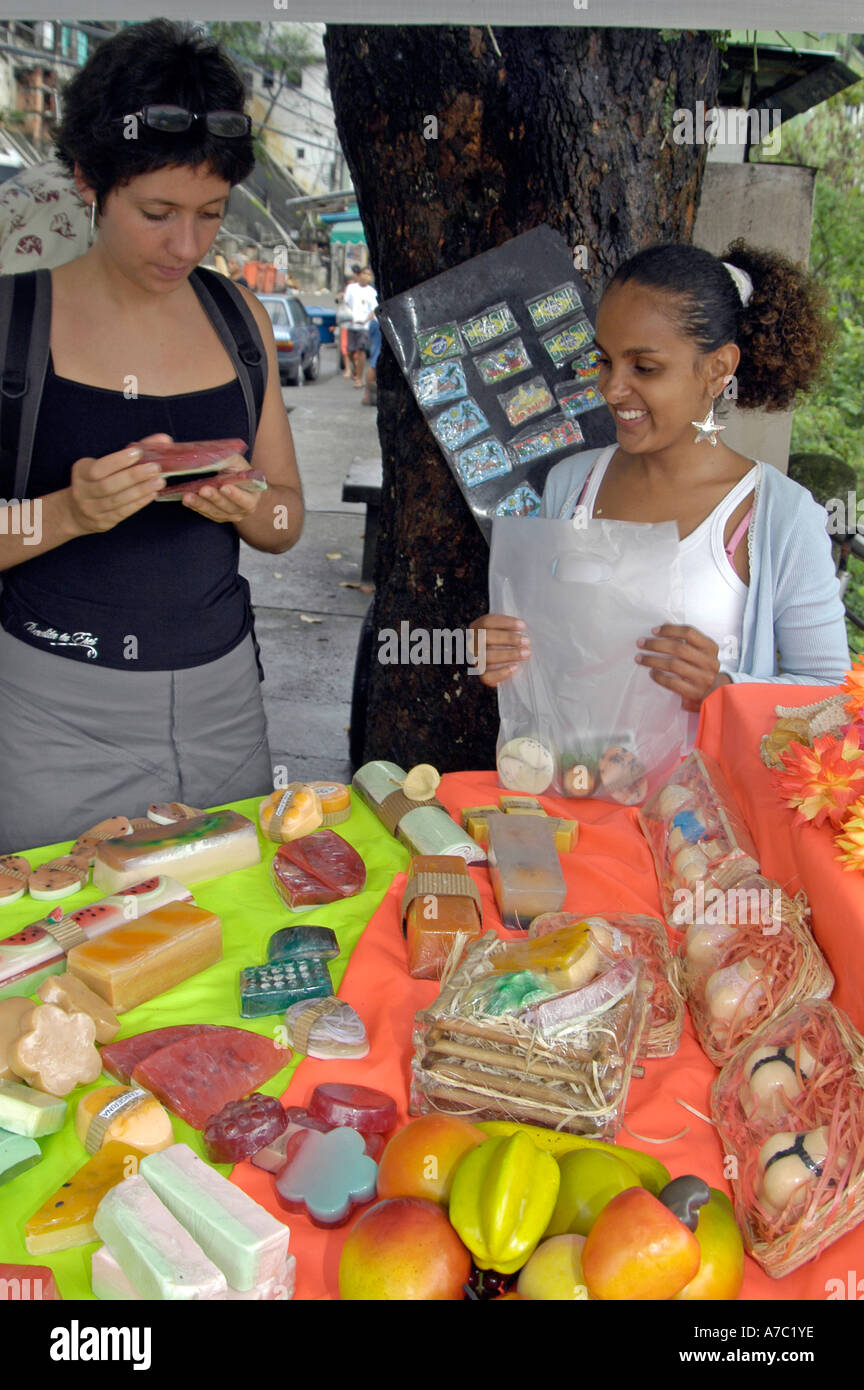 Tourists buying sculptured soap in Rocinha favela, Rio de Janeiro ...