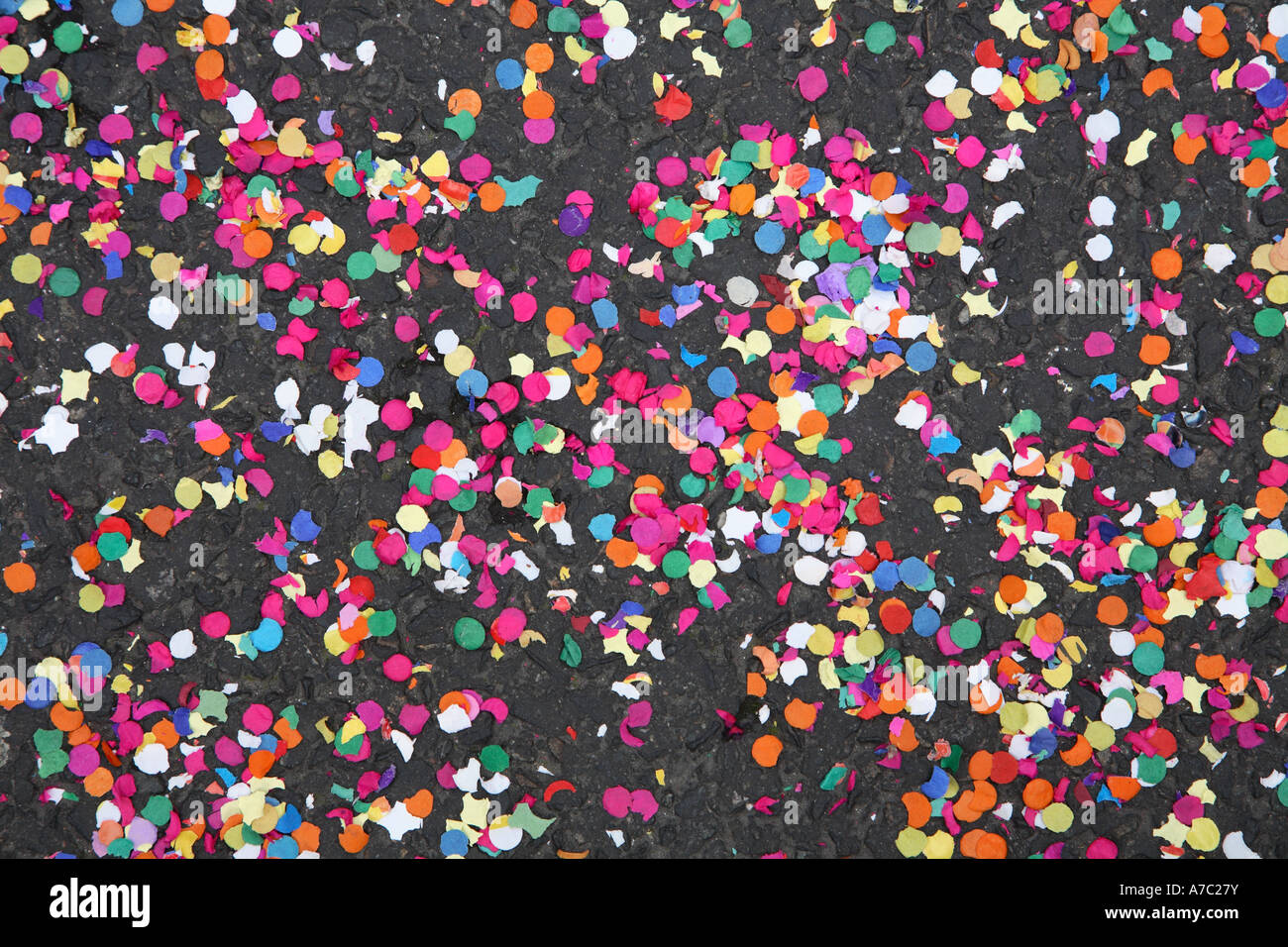 confetti on the road after carnival parade Stock Photo - Alamy