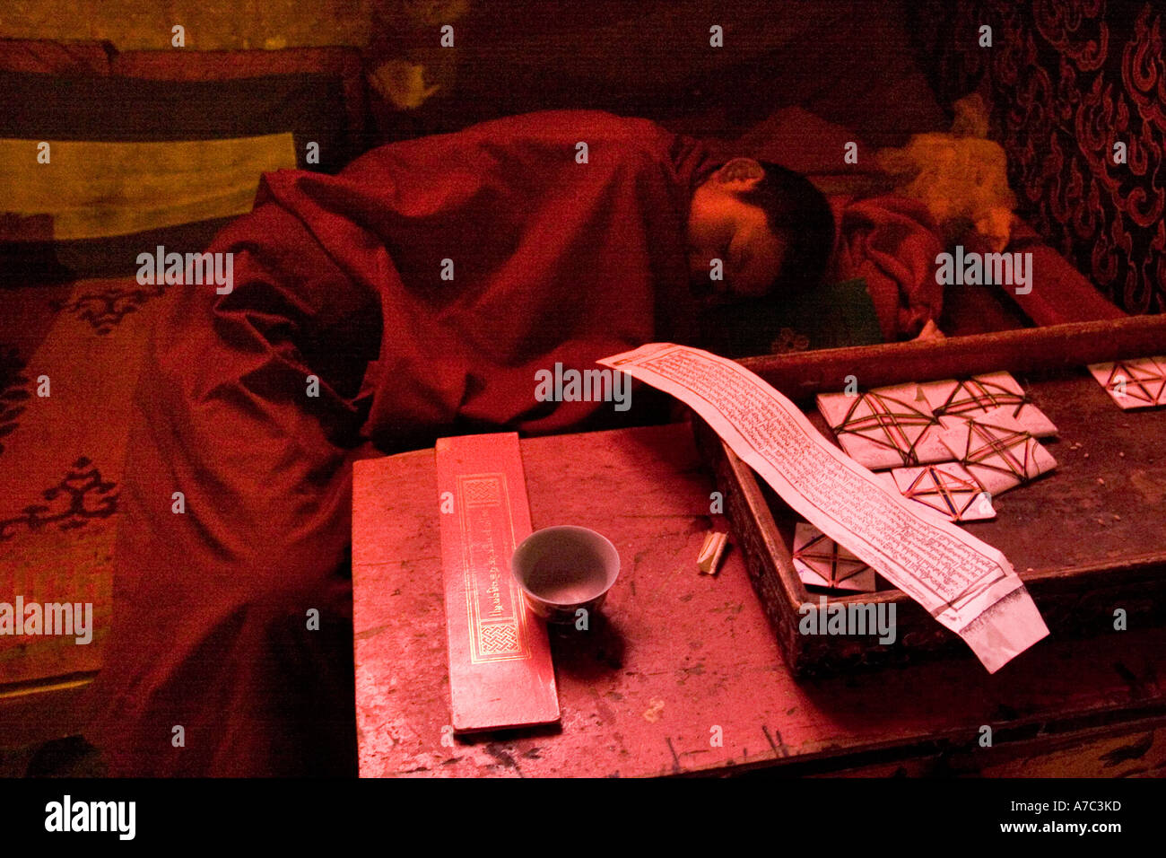 Monk asleep with prayers inside one of the assembly hall of Sakya ...