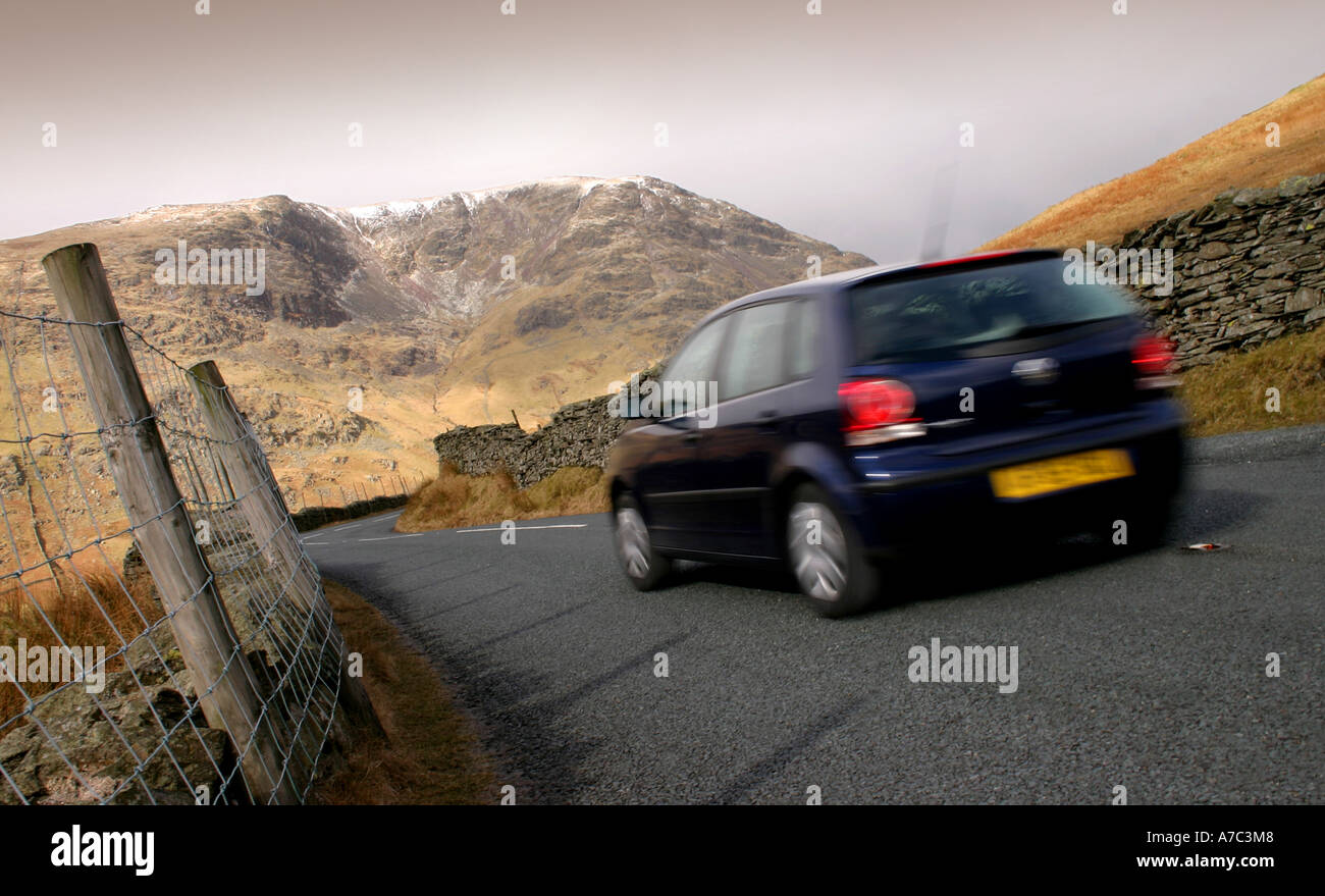 Cars passing on the road near The Lakes in Cumbria United Kingdom Stock ...