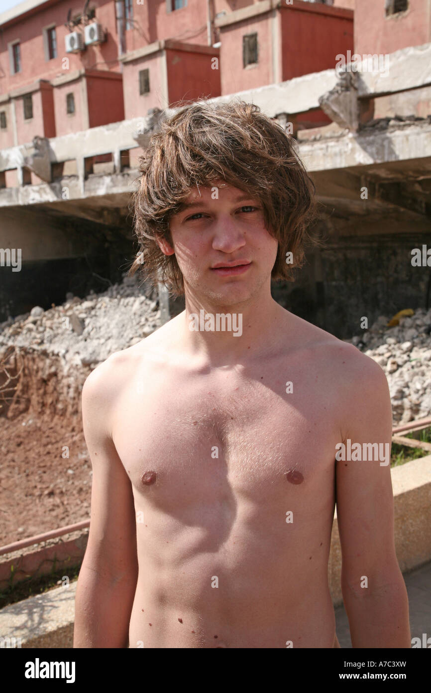 Head torso bare chested teenage boy standing in construction building ... Head torso bare chested teenage boy standing in construction building ...