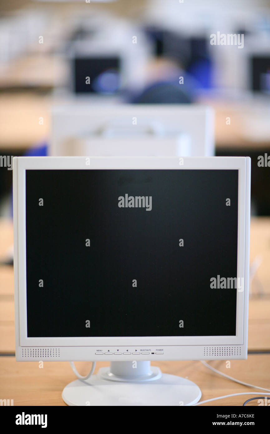 close-up of Flat computer monitor screen and mouse in large open plan ...