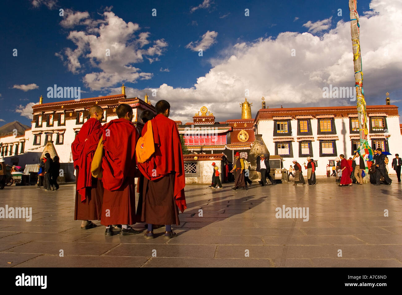Monks pilgrim and tourist in front of the Jhokang temple in old Lhasa ...