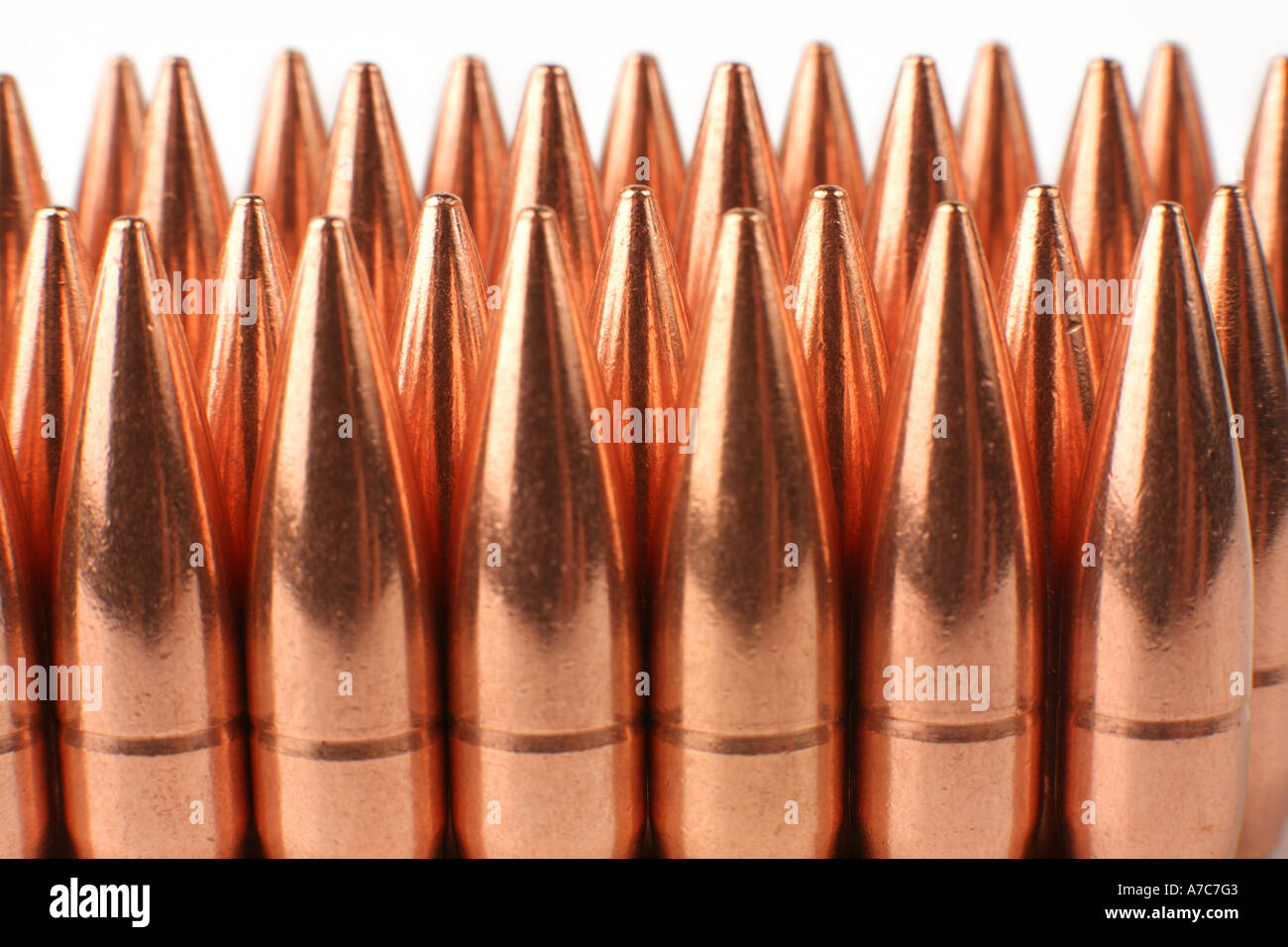 Group of bullets standing in rows. 308 rifle bullets arranged in rows ...