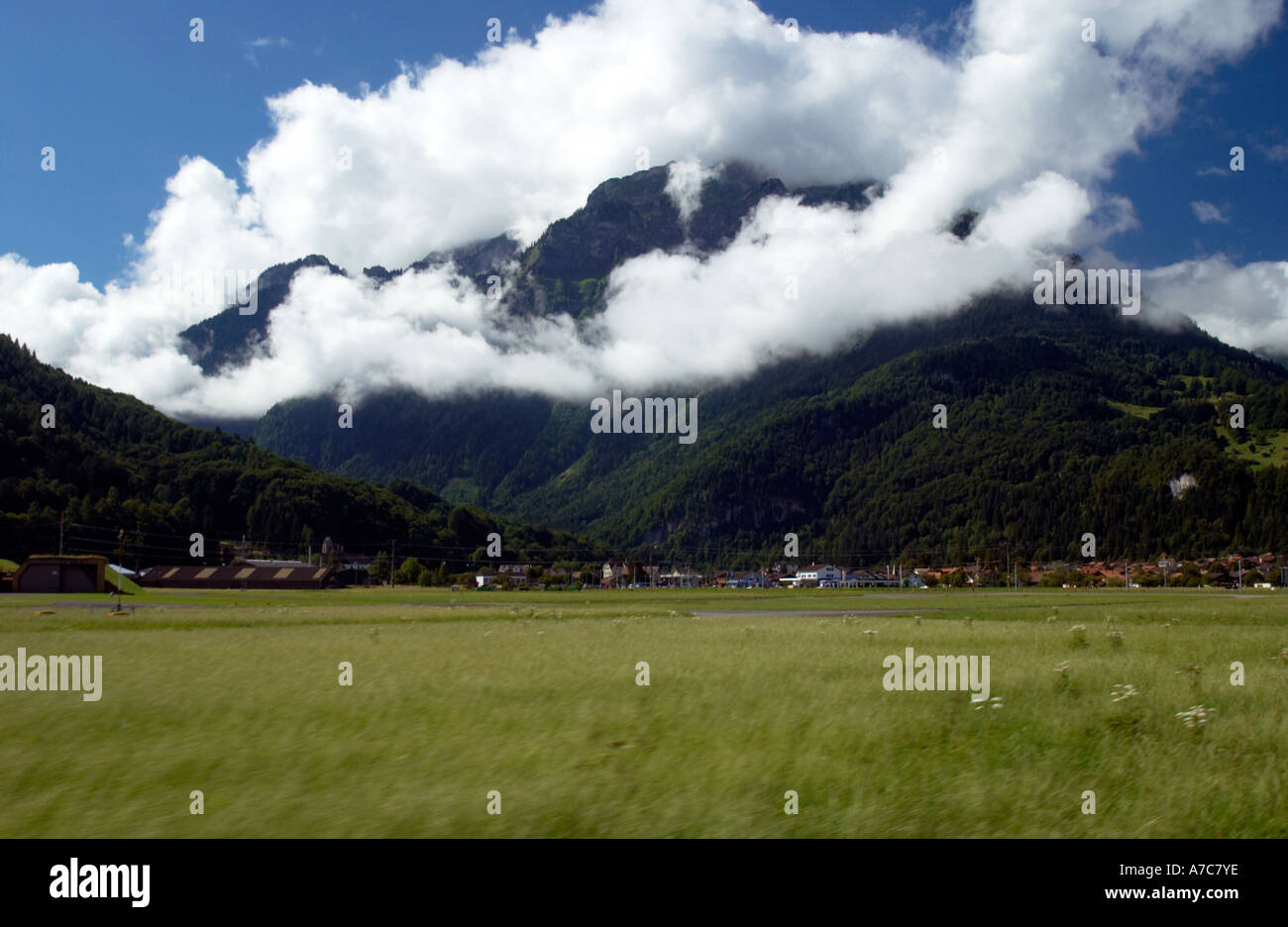 View across meadow towards the Swiss Alps Stock Photo - Alamy