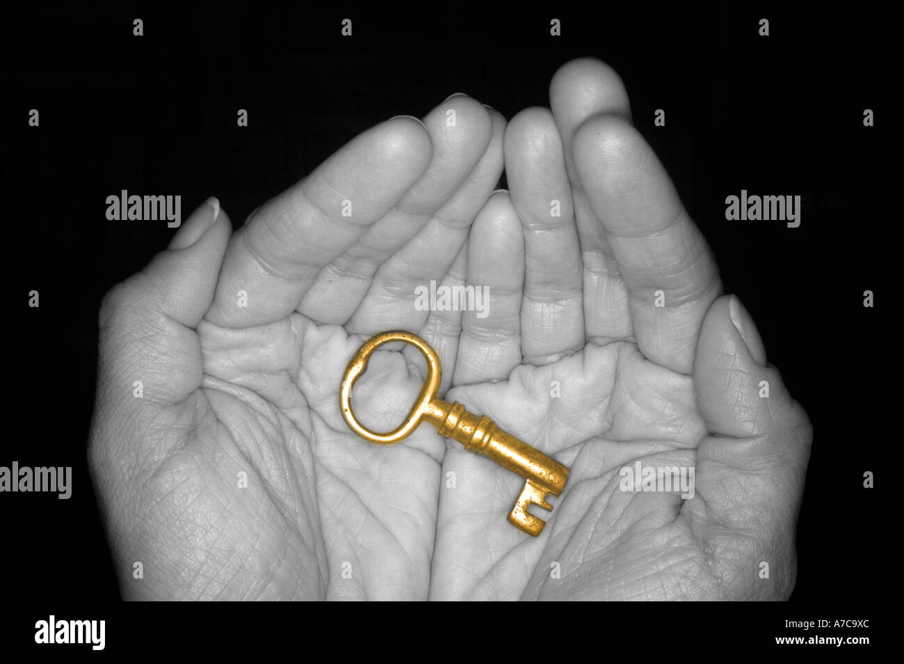 hand holding a golden key secrets secret keys knowledge Stock Photo - Alamy