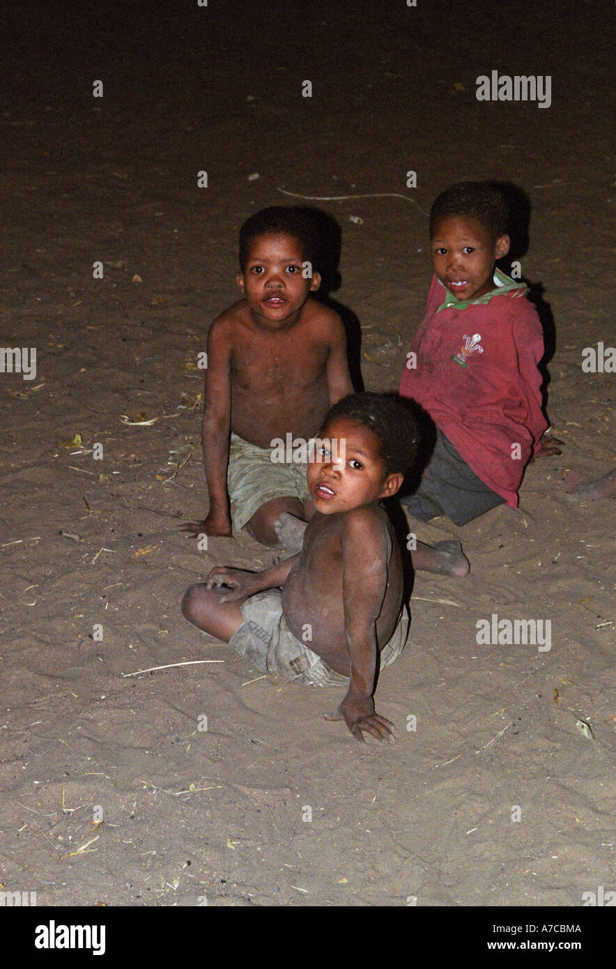 San Bushman sitting children village in night Botswana Stock Photo - Alamy