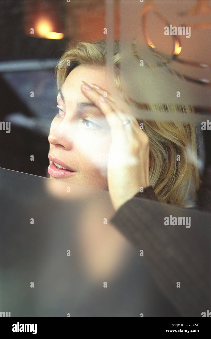 Woman behind a window watching outside Stock Photo - Alamy