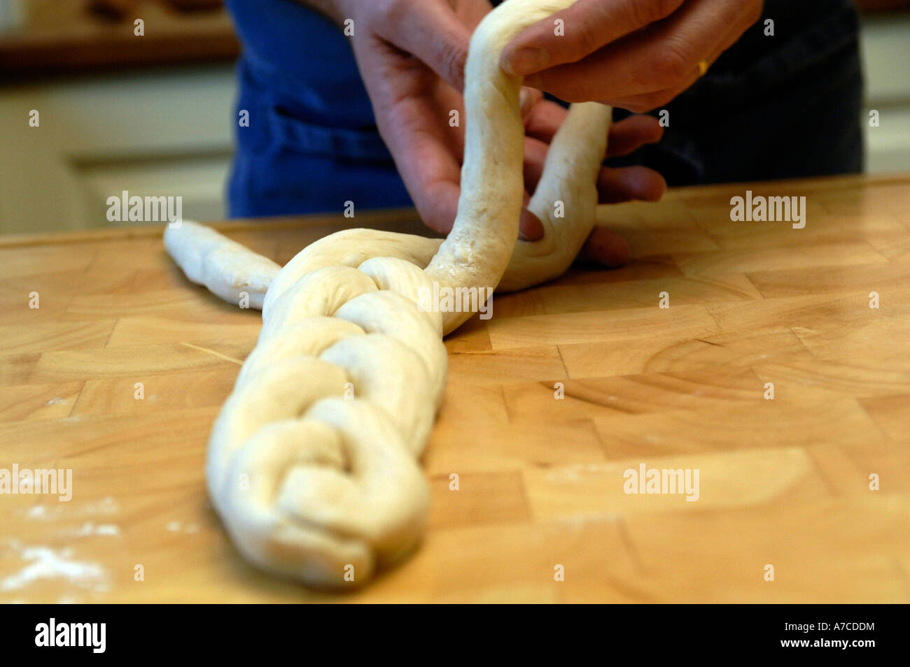 Braiding a bread plait Stock Photo - Alamy