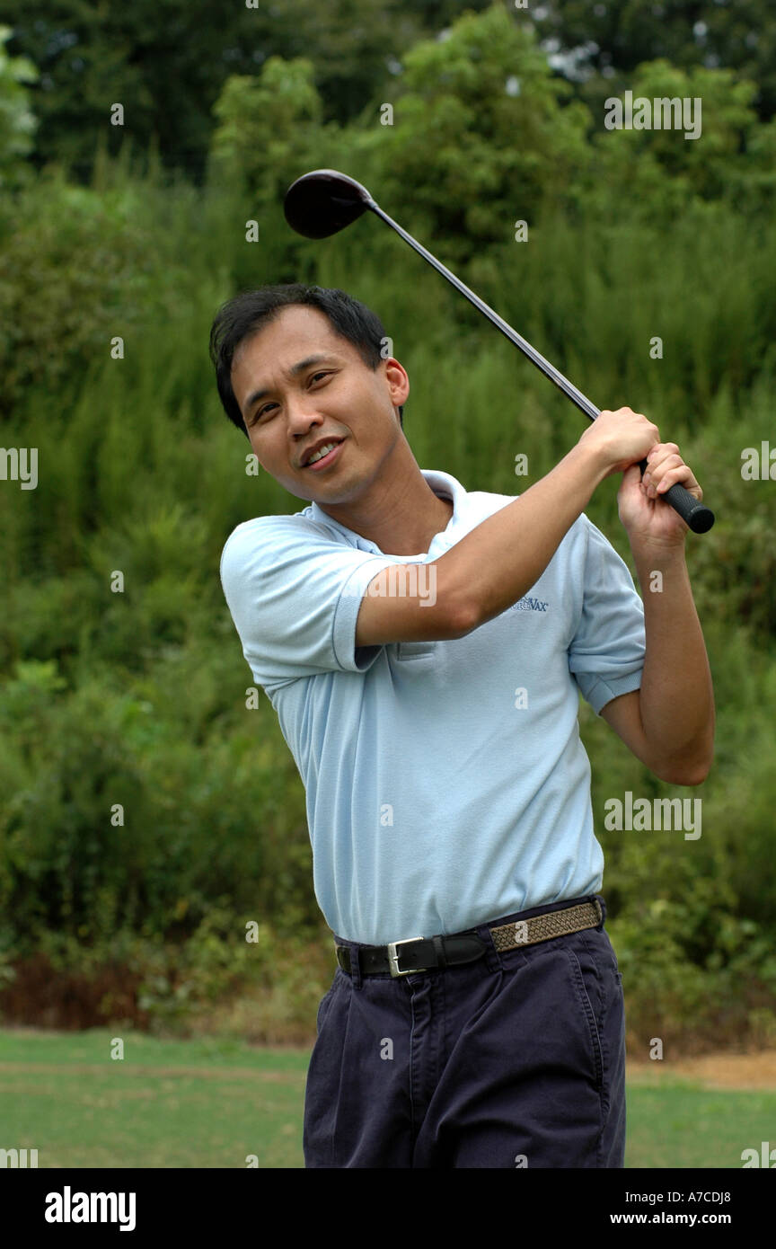Asian man playing golf MR Robin Nelson Stock Photo - Alamy