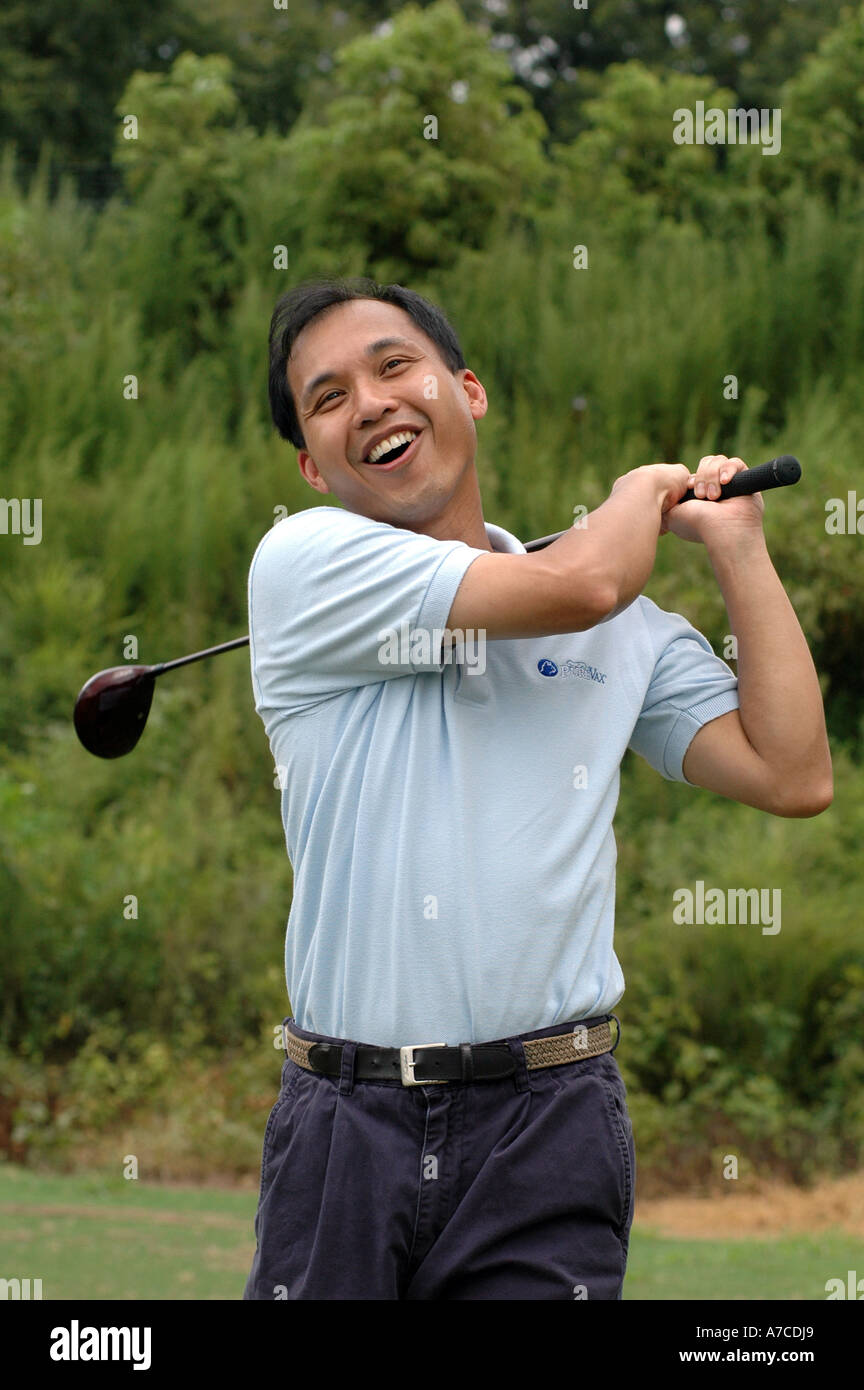 Asian man playing golf MR Robin Nelson Stock Photo - Alamy