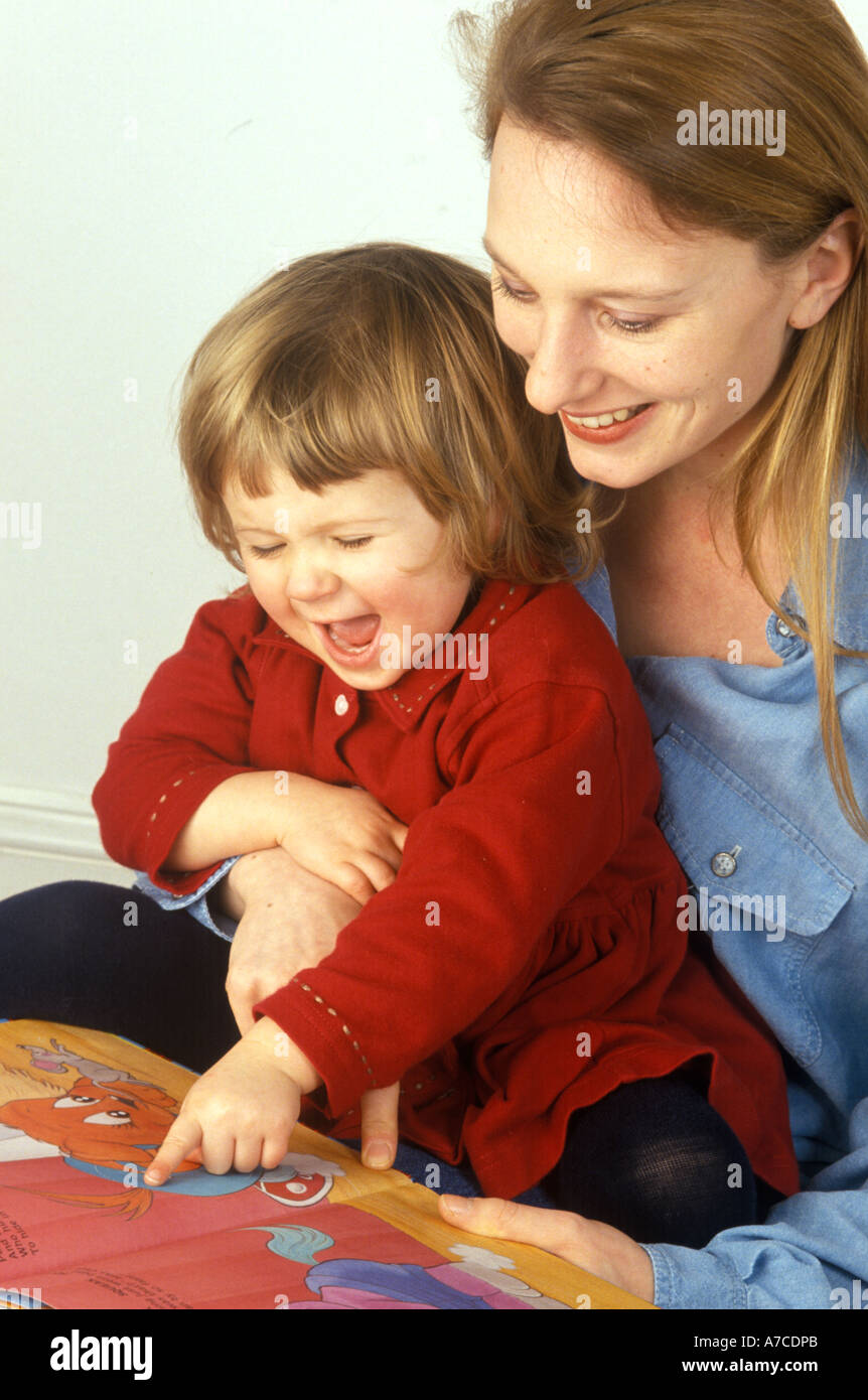 Mother and child reading together Stock Photo - Alamy