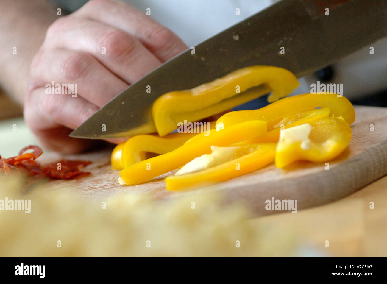 Slicing a yellow pepper Stock Photo - Alamy
