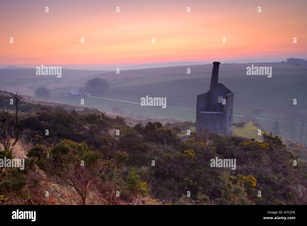 Derelict mine engine Wheal Betsy near Tavistock with the orange glow of ...
