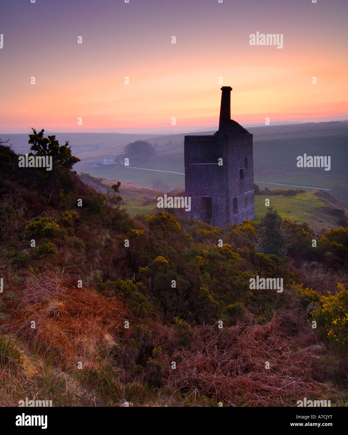 Derelict mine engine Wheal Betsy near Tavistock with the orange glow of ...