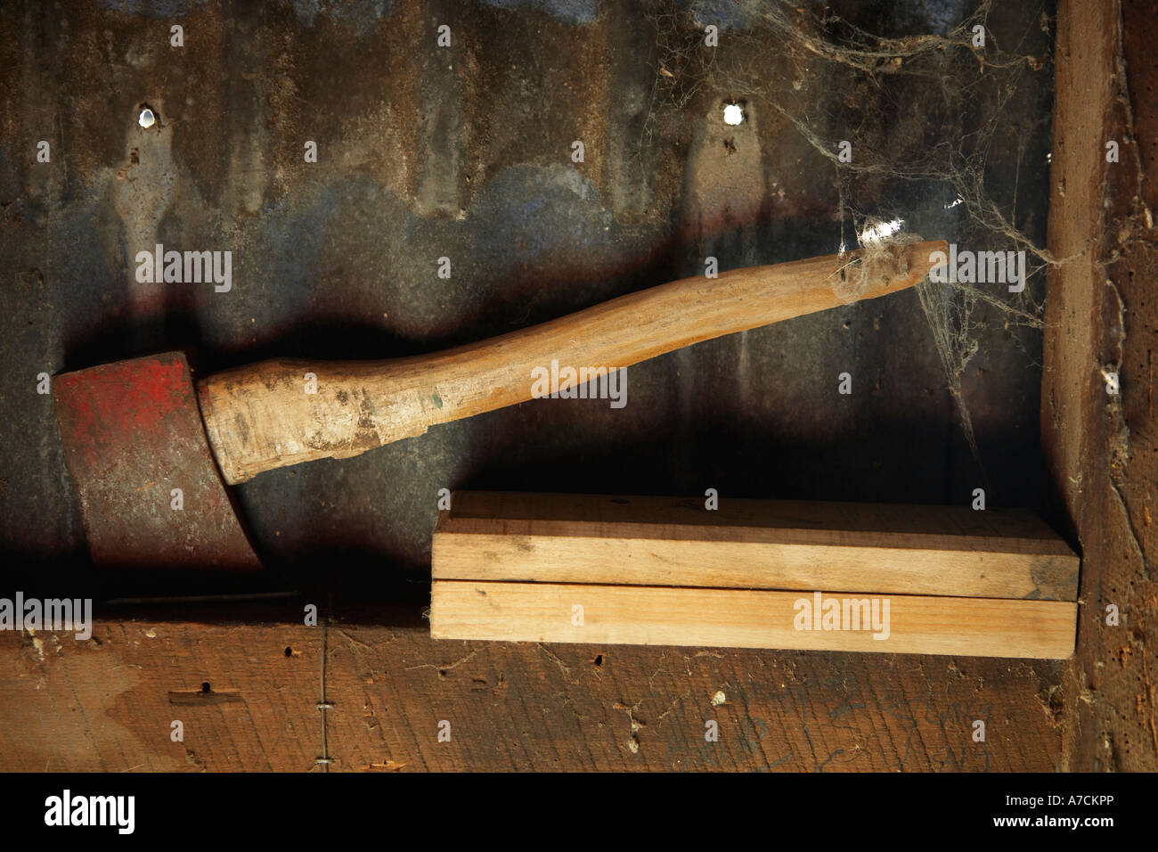 old axe hand tool in shed with sharpening stone Stock Photo - Alamy