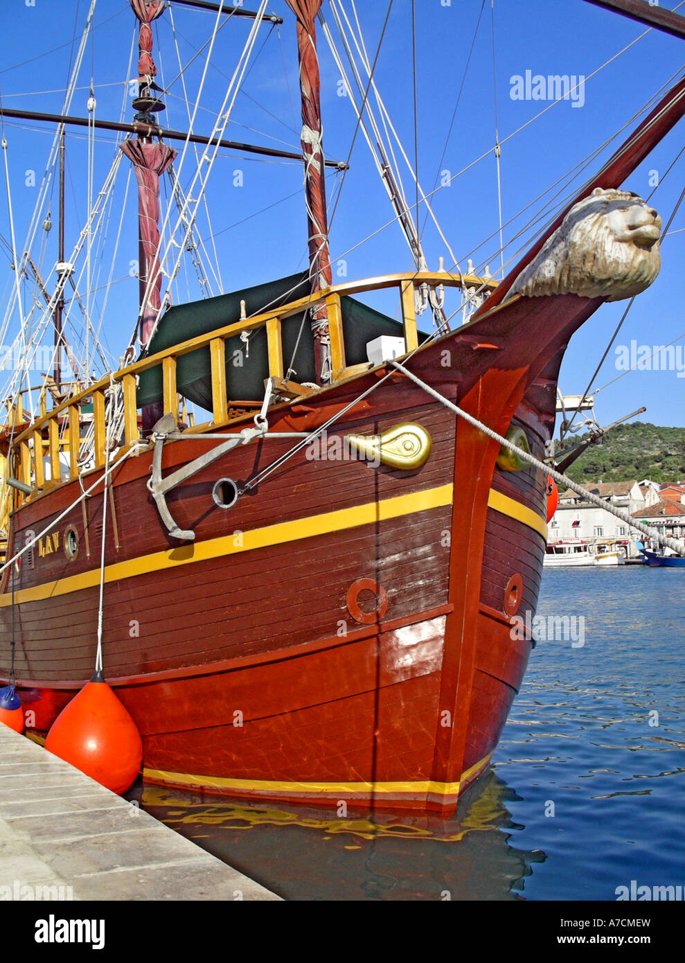 Modern wooden hulled holiday cruise ship berthed in the port of Trogir ...
