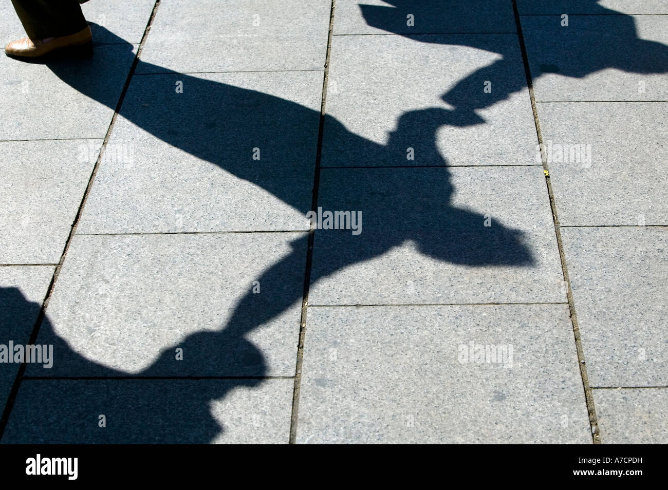 Three shadows holding hands hi-res stock photography and images - Alamy