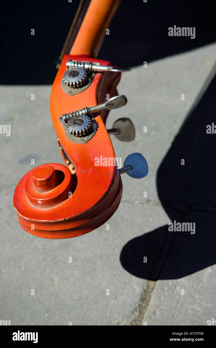 Shadow of scroll and neck of double bass on ground La Sardana dance Pla ...