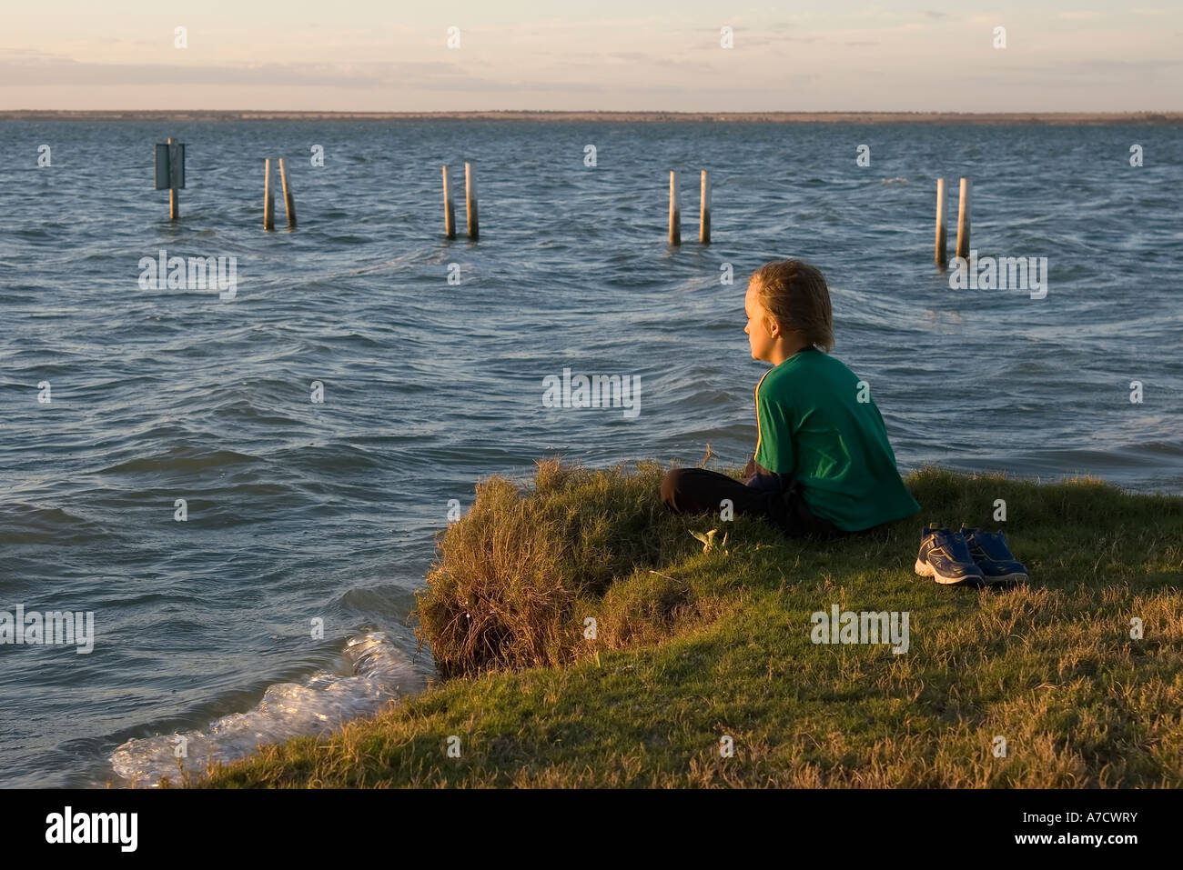 boy looking over lake Stock Photo - Alamy