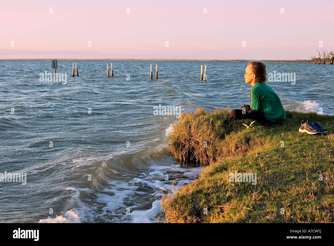 boy looking over lake Stock Photo - Alamy