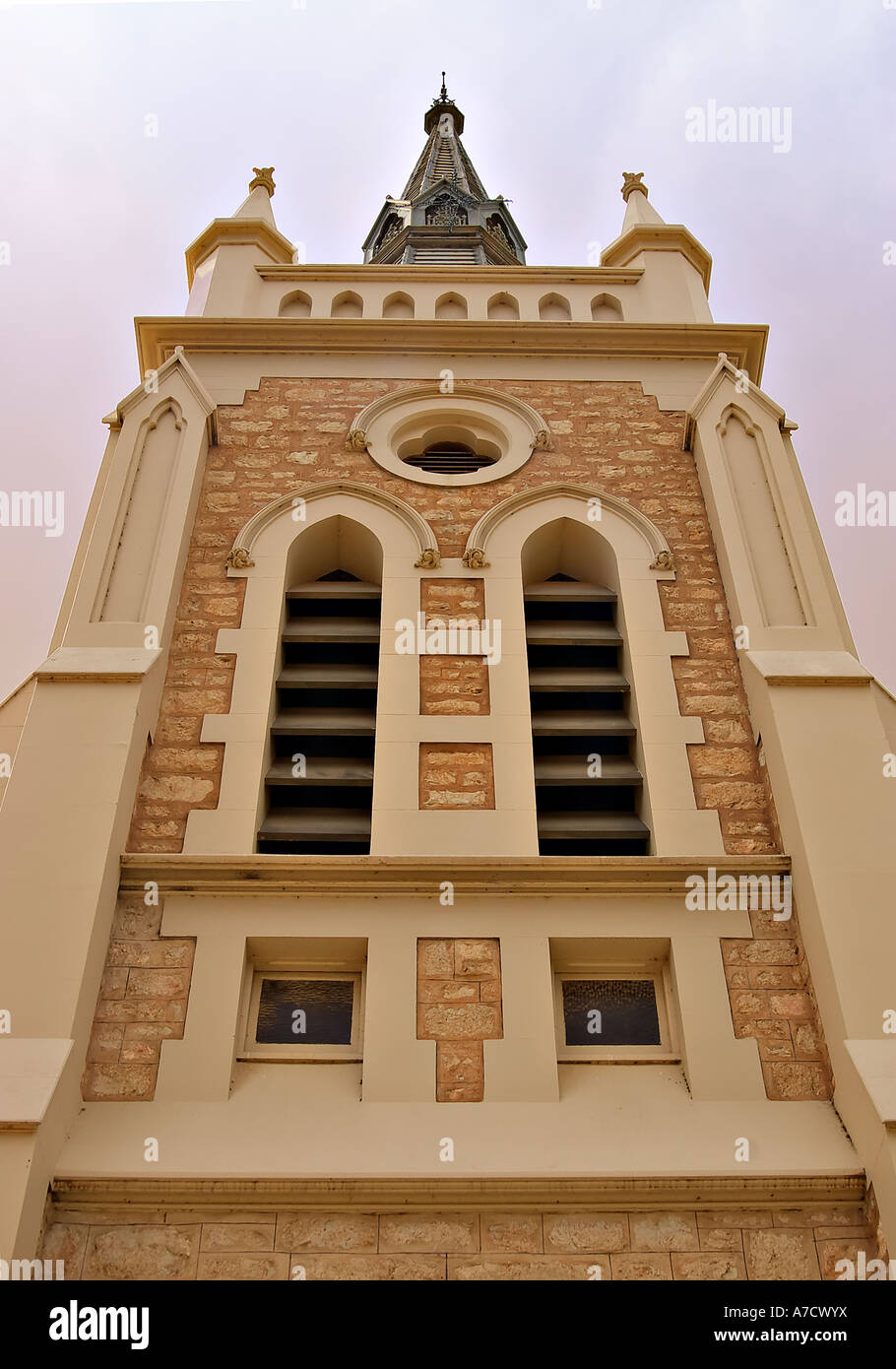tall imposing stone church tower with pinkish sky Stock Photo - Alamy