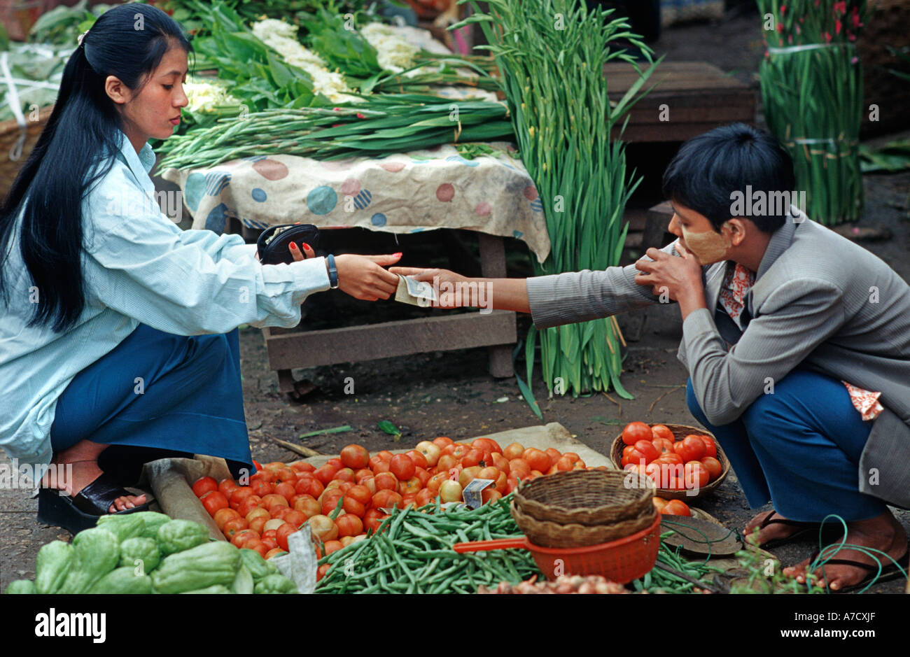 A market transaction Money changes hands Fruit vegetable vendor with ...