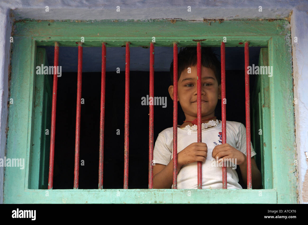 Child looking out a barred window in Jodhpur India Stock Photo - Alamy