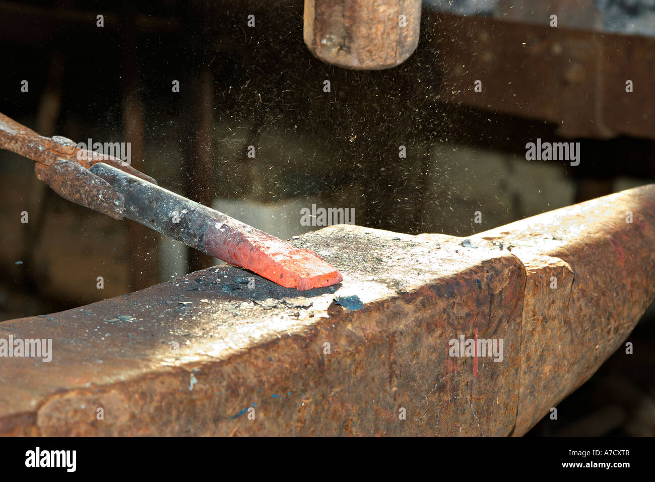 strike while the irons hot series 3 sparks flying Stock Photo - Alamy