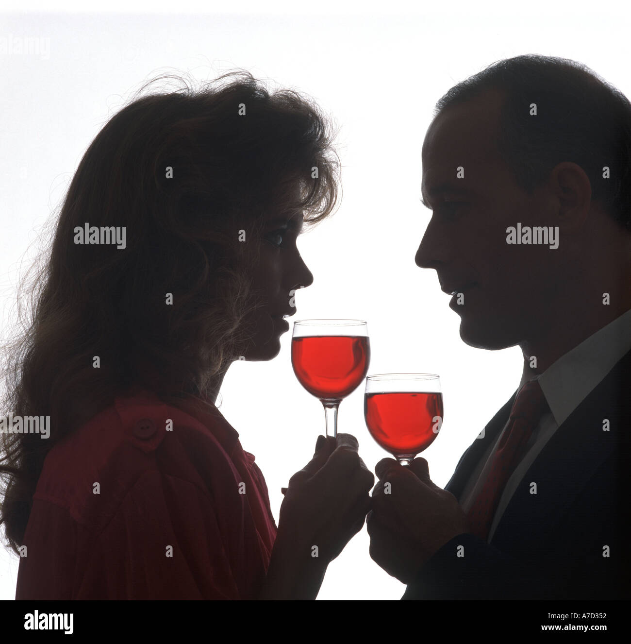 couple making a toast with red wine Stock Photo - Alamy