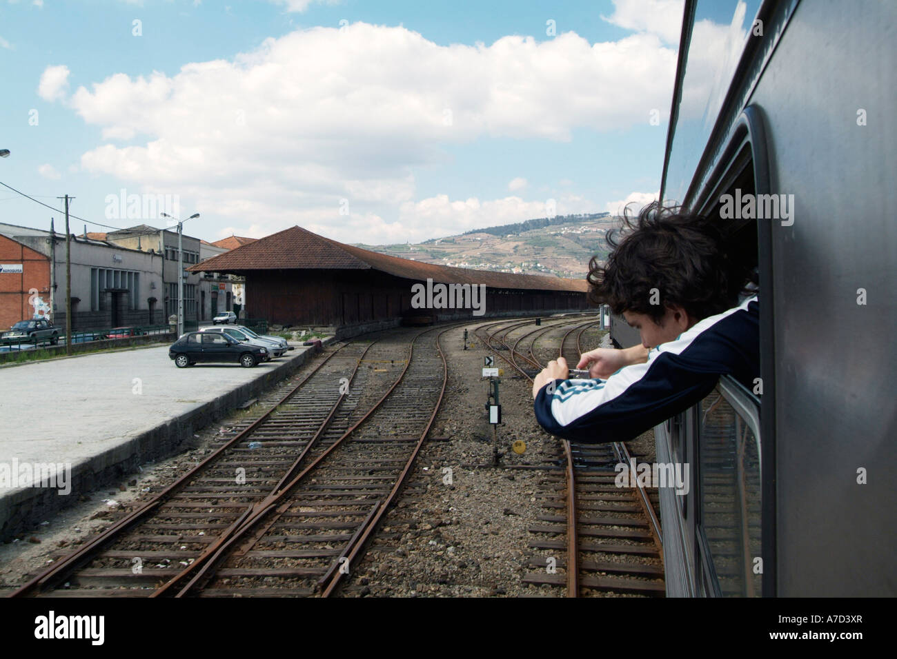 young man taking a photo from the train window Stock Photo - Alamy