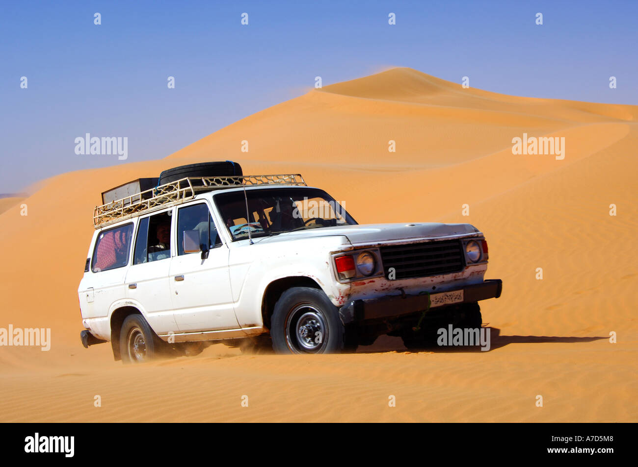 Four-wheel drive jeeps toil through the sands of the Ubari Sand Sea ...