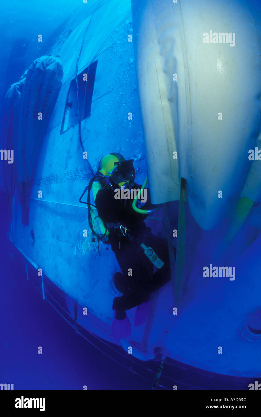 A COMMERCIAL DIVER FILLS A LIFT BAG IN AN ATTEMPT TO RIGHT THE ...