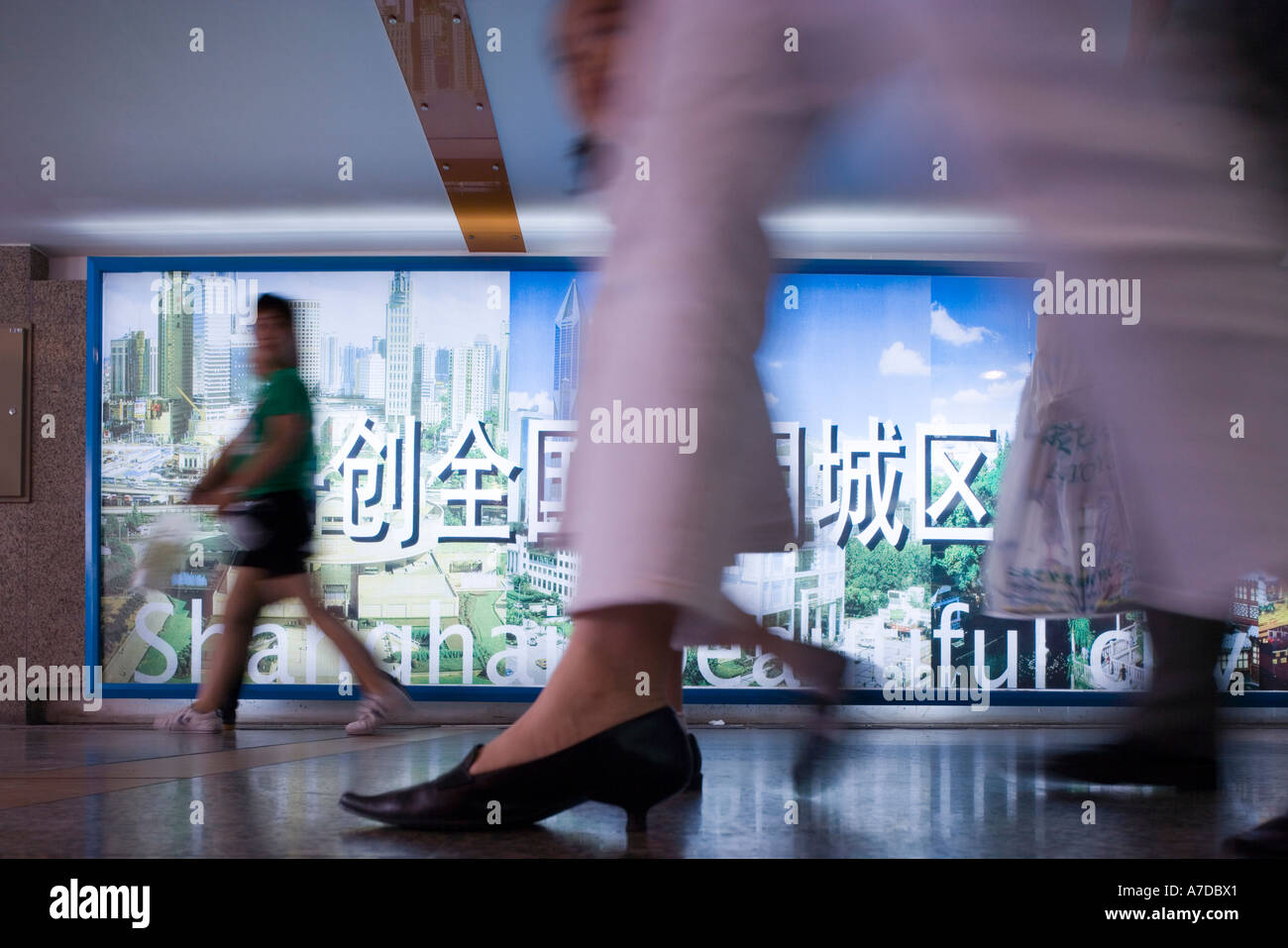 Asia China Shanghai Pedestrians walk past signboard showing Shanghai ...