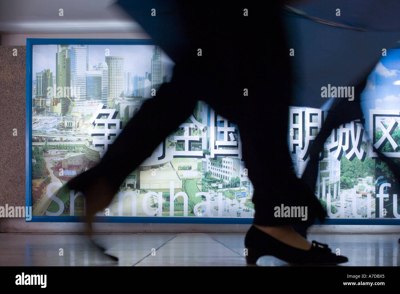 Asia China Shanghai Pedestrians walk past signboard showing Shanghai ...