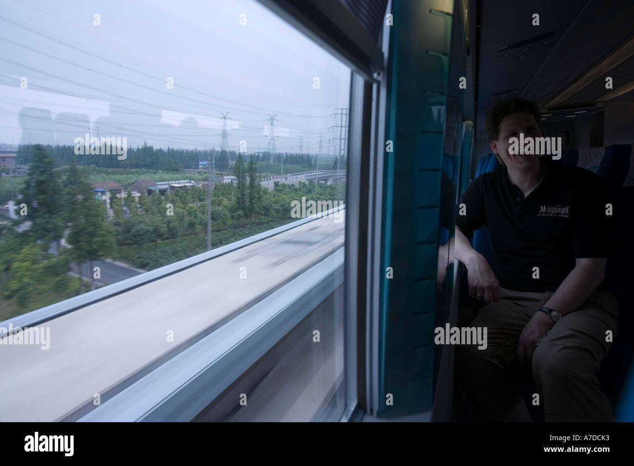 Asia China Shanghai European tourist looks out window of speeding ...